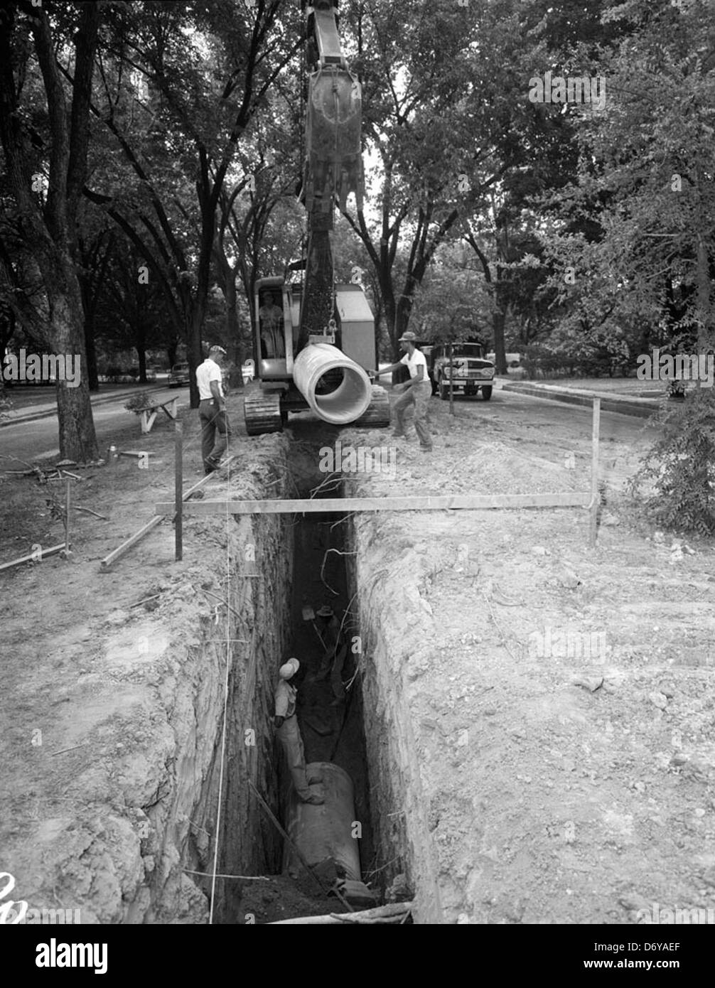 This 1950s photograph shows the construction of a sewer system along ...