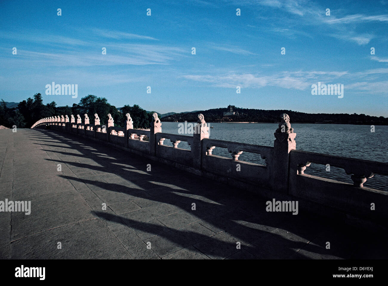 Bridge adorned with lion statues next to a river, Summer Palace ...