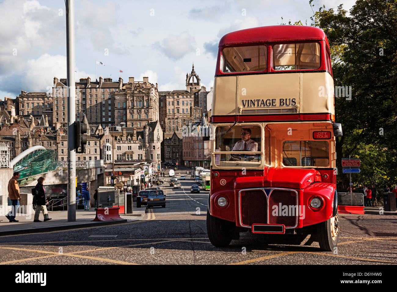 Vintage double-decker bus driving on the street during the day in ...