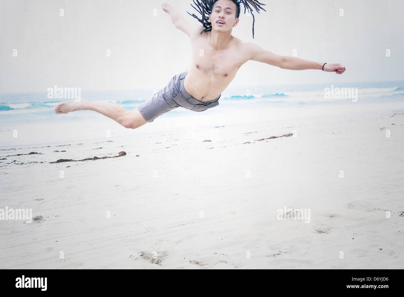Chinese man jumping on beach Stock Photo - Alamy