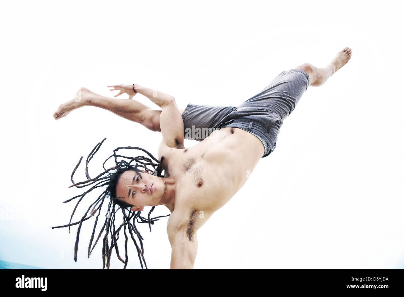 Chinese man jumping on beach Stock Photo - Alamy