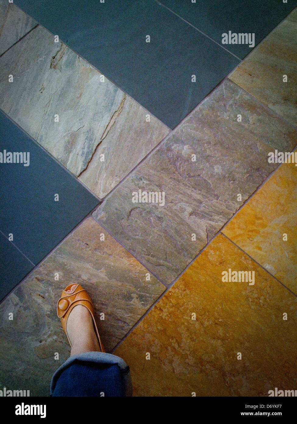 Woman's foot on stone tile floor Stock Photo - Alamy