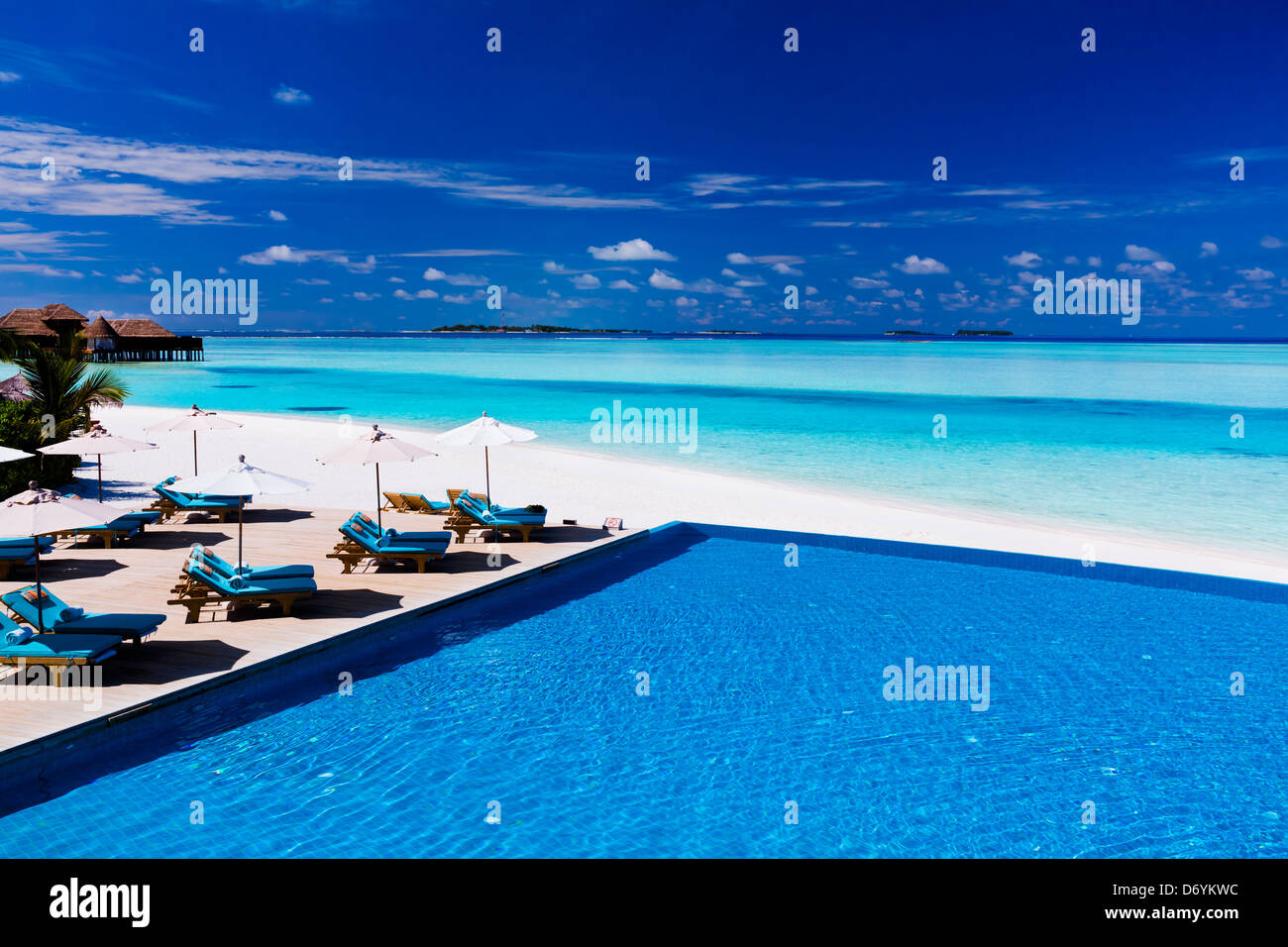 Deck and infinity pool over amazing tropical lagoon Stock Photo - Alamy