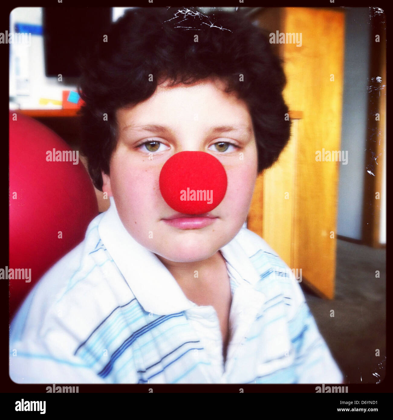 Boy wearing red clown nose Stock Photo - Alamy