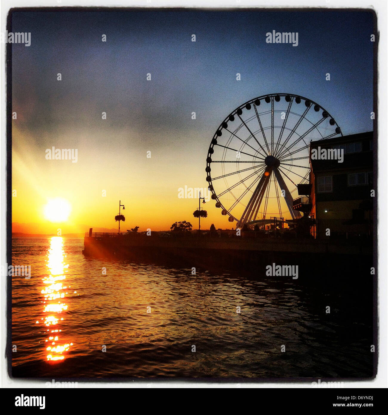 Silhouette of Ferris wheel on boardwalk at sunset, Seattle, Washington ...