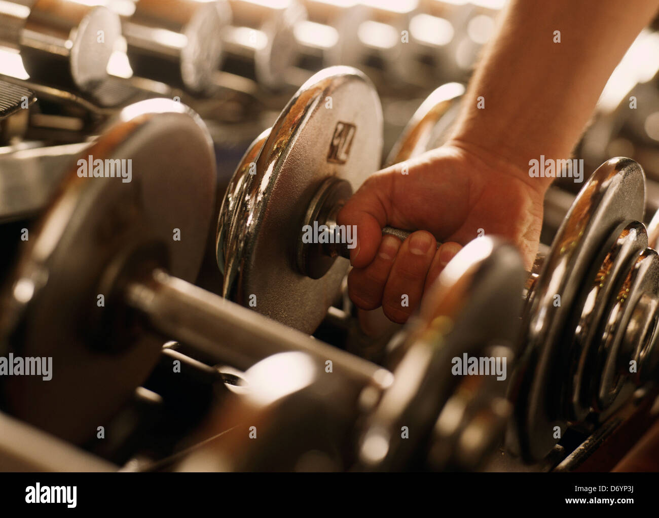 Man's hand grabbing a weight at a gym Stock Photo - Alamy