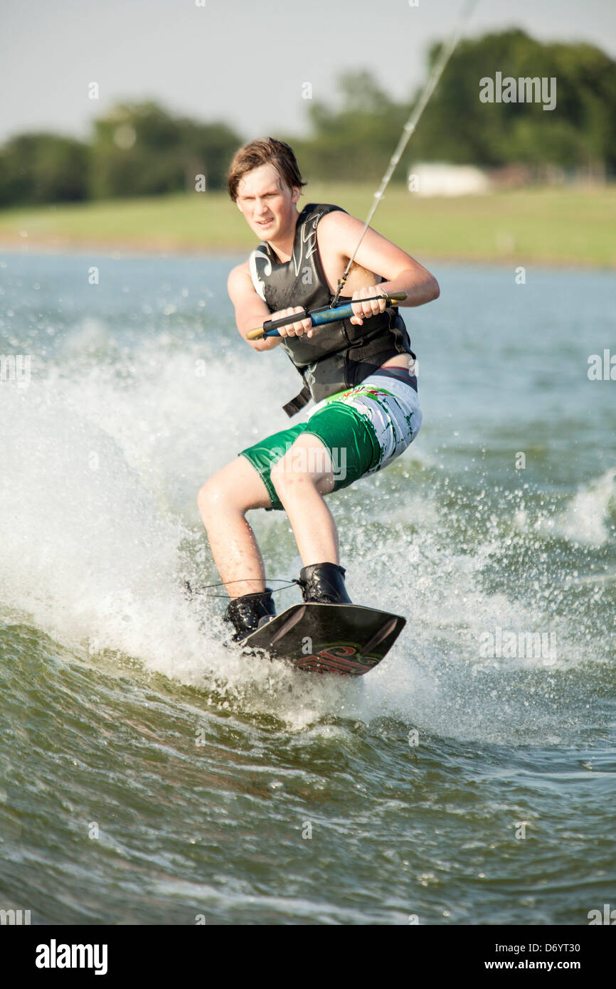 Teenage girl wakeboarding on lake Stock Photo - Alamy