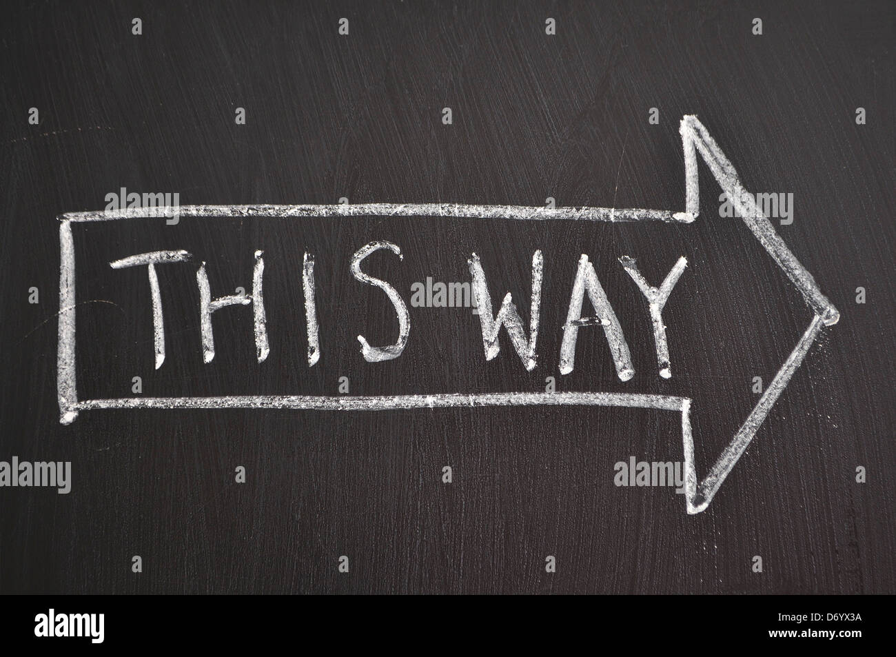 hand drawn arrow on chalkboard and this way words Stock Photo - Alamy