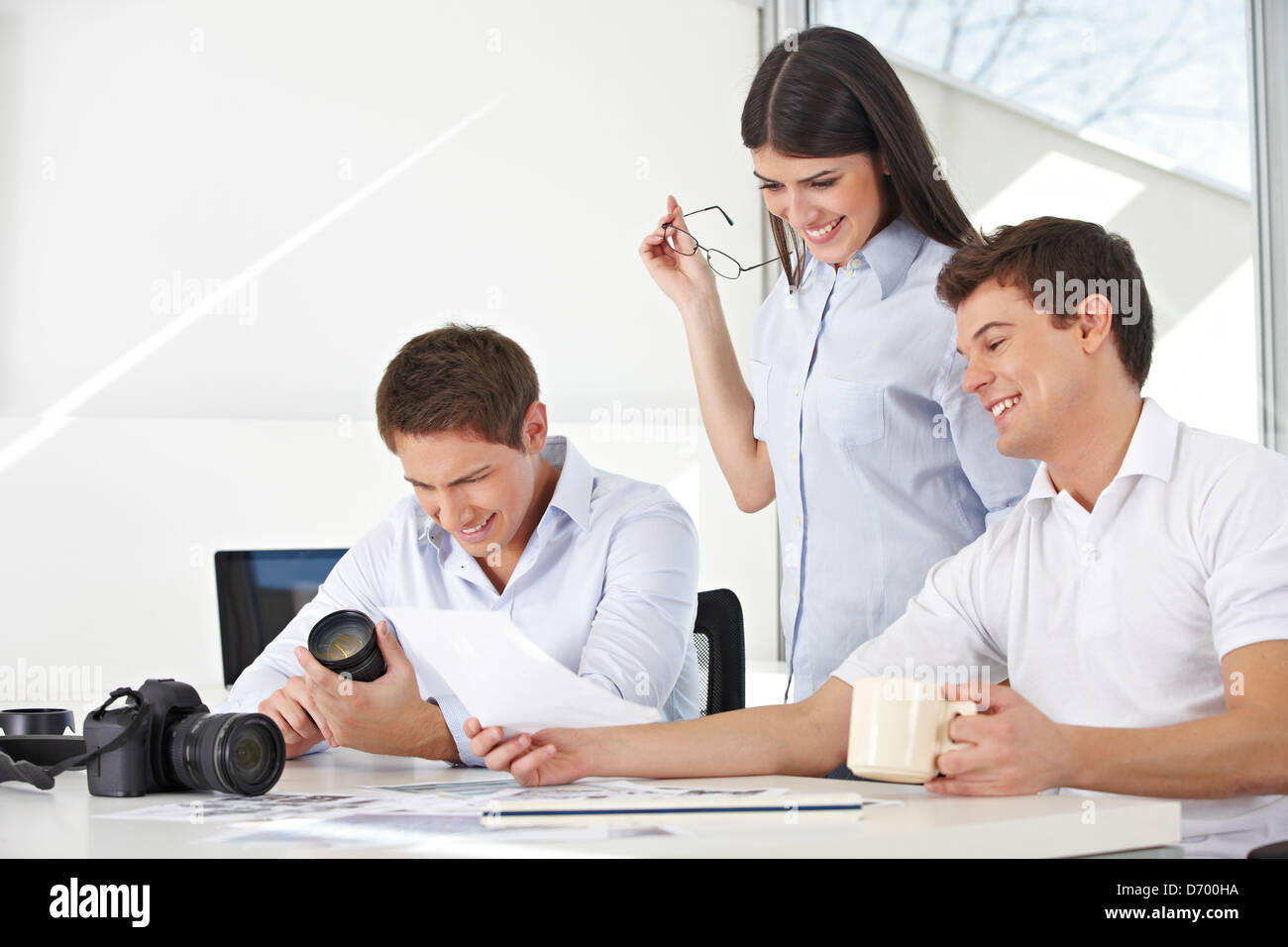 Photographer team with camera and lenses selecting images Stock Photo ...