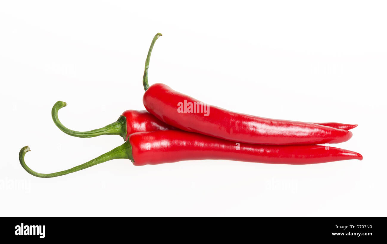 three red chili peppers, isolated on white Stock Photo - Alamy