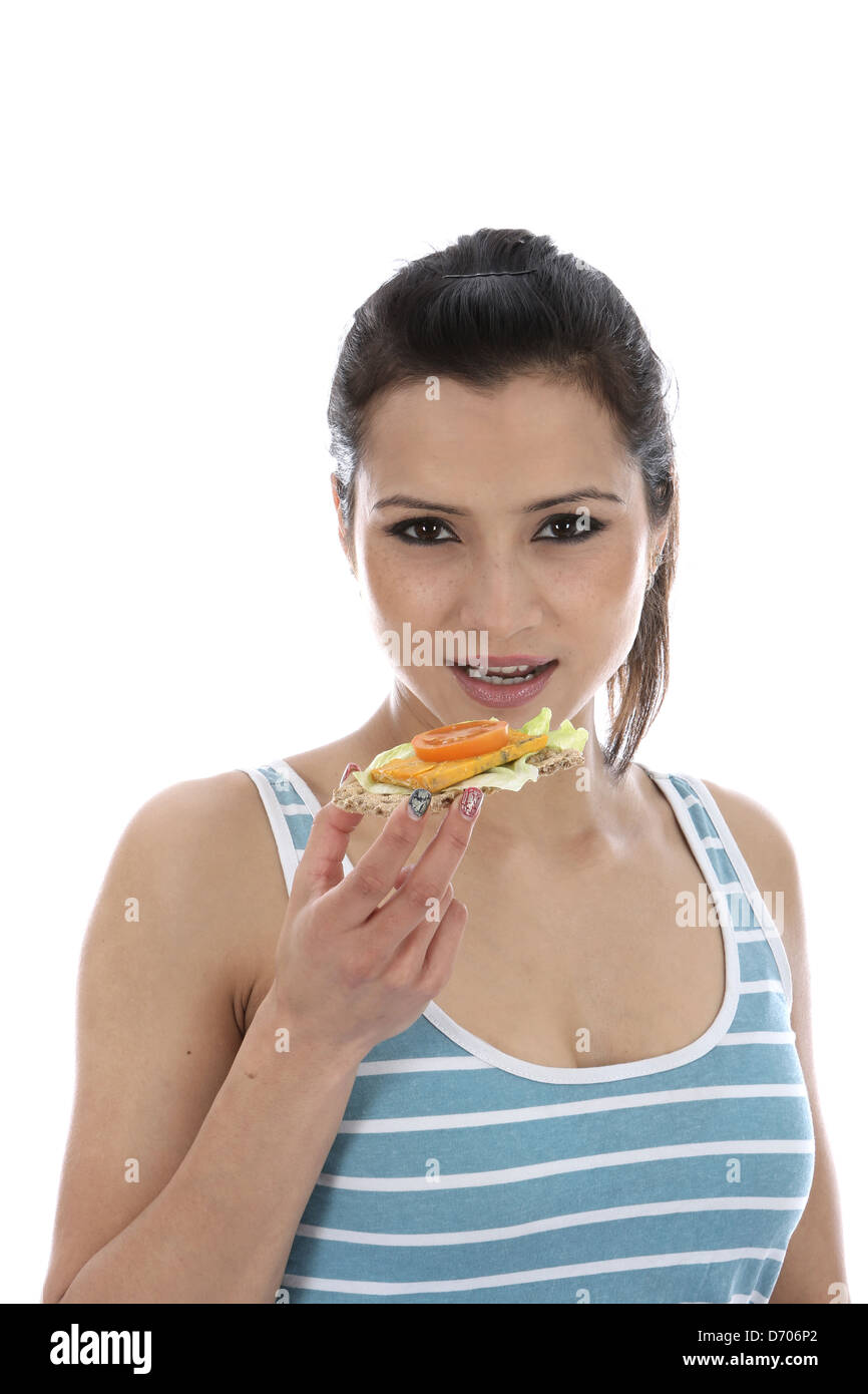 Model Released. Woman Eating Cheese and Cracker Stock Photo - Alamy