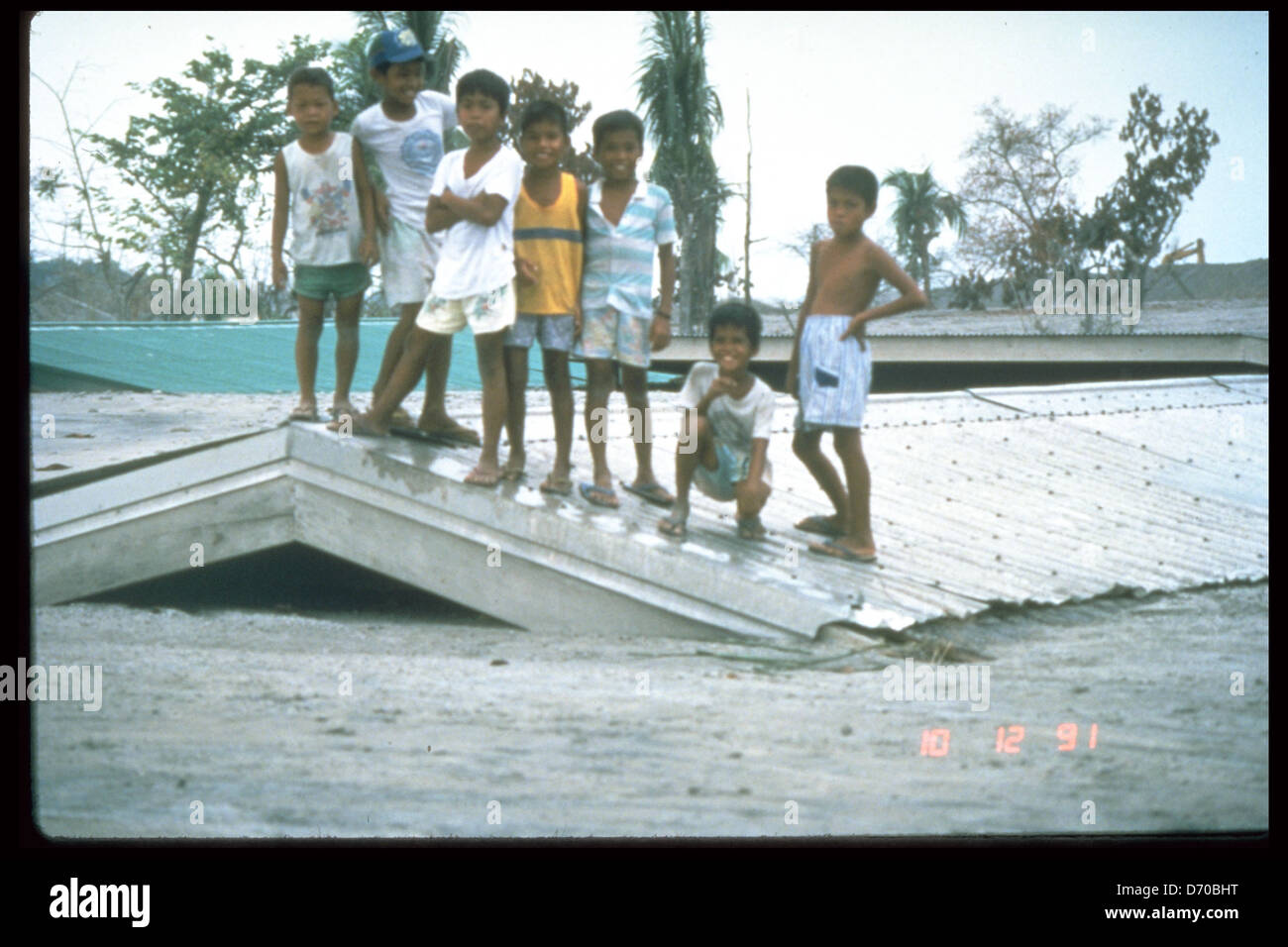 This photograph captures children on a roof in Bamban, Philippines, on ...