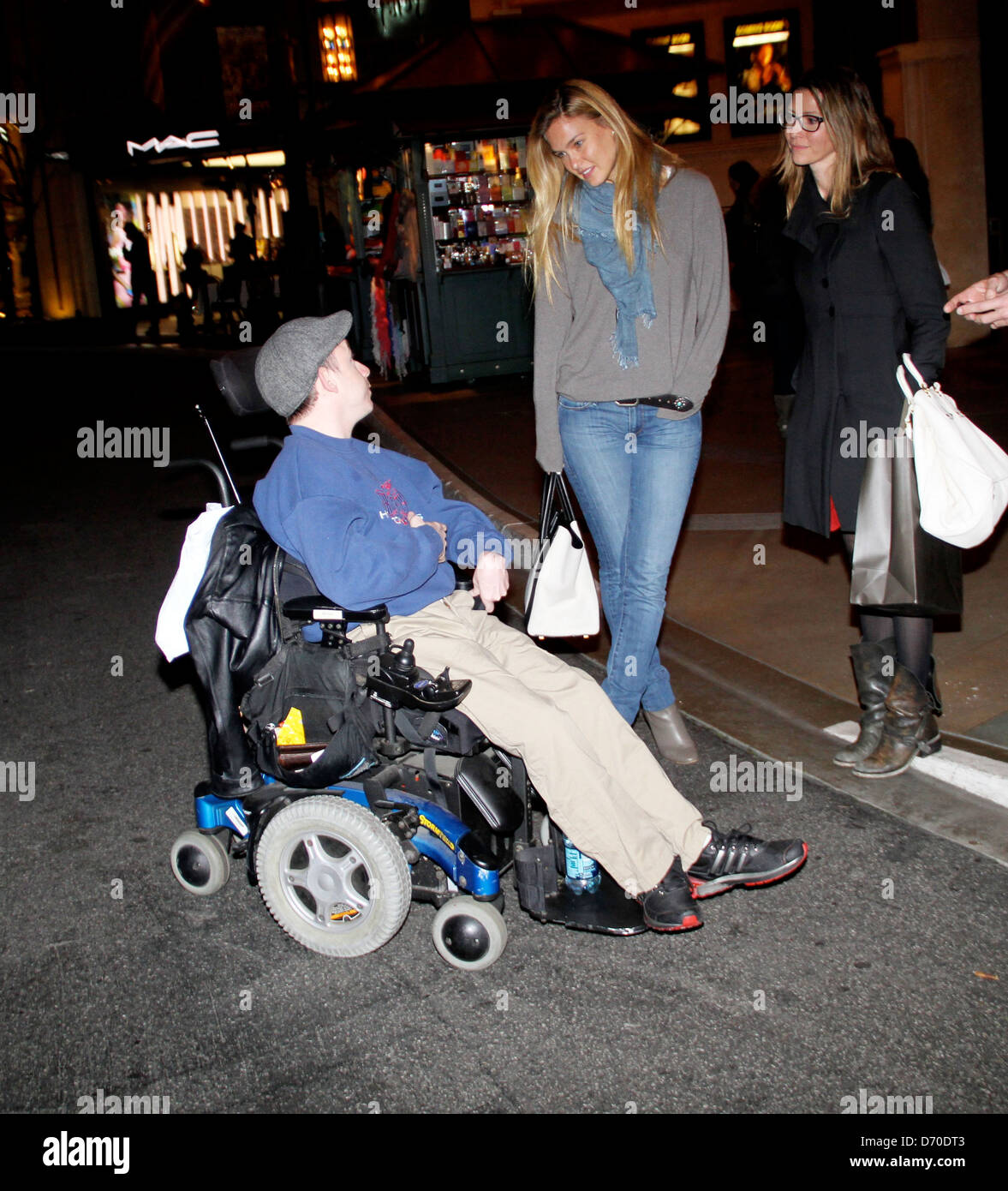 Bar Refaeli and friend talk to a man in a wheelchair at The Grove in ...