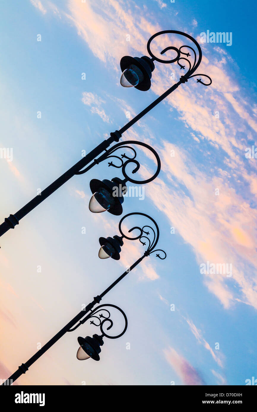 Silhouetted ornate street lights at sunset along the Krakowskie ...