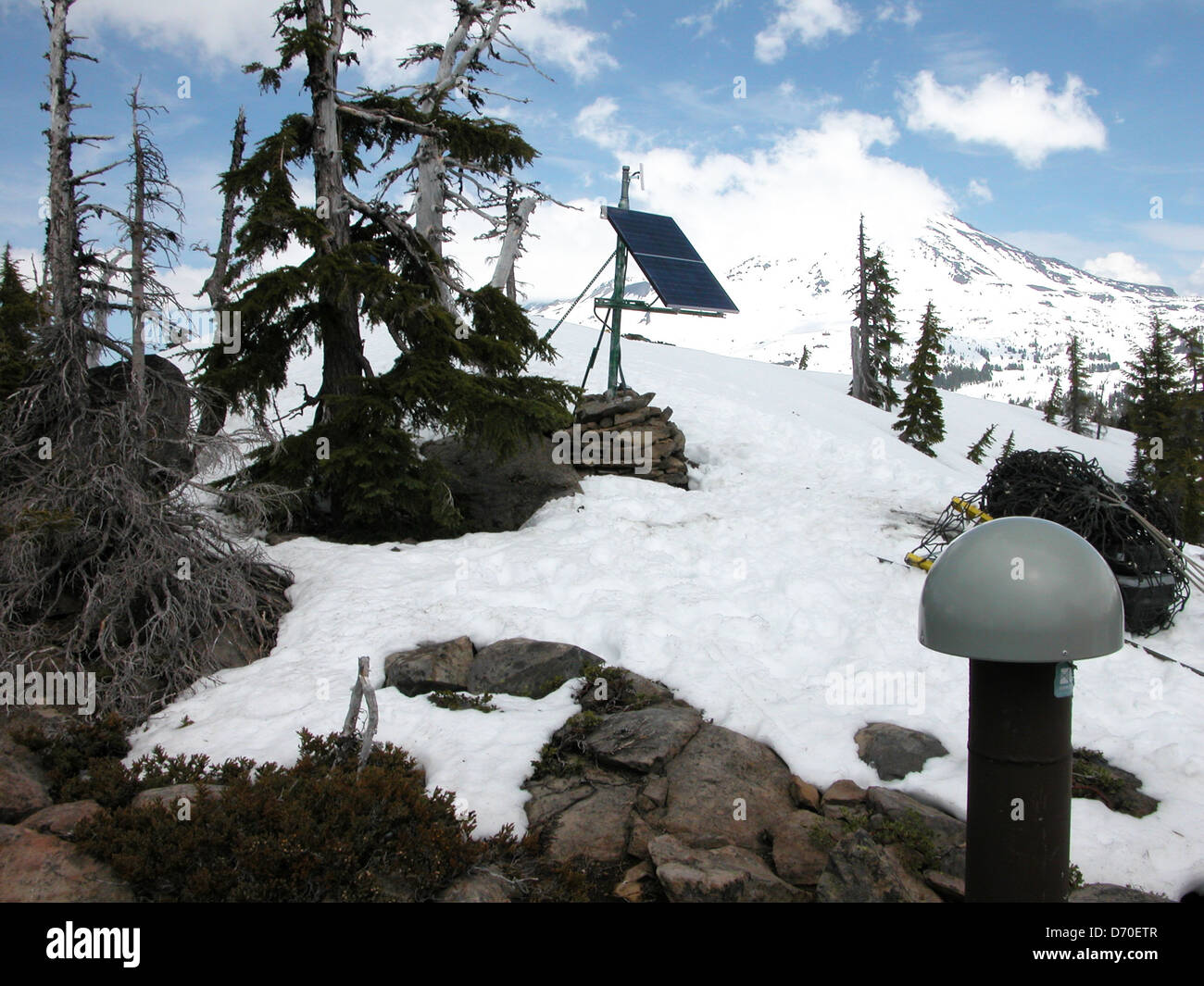 This image captures a view of the Sisters volcanoes and Sparks Lake ...