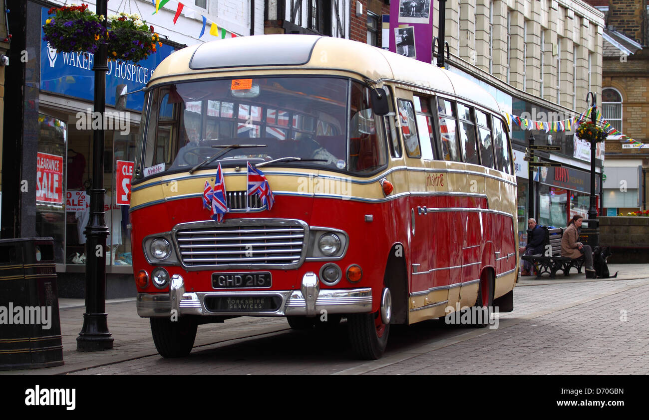 Vintage coach parked outside shops Stock Photo - Alamy