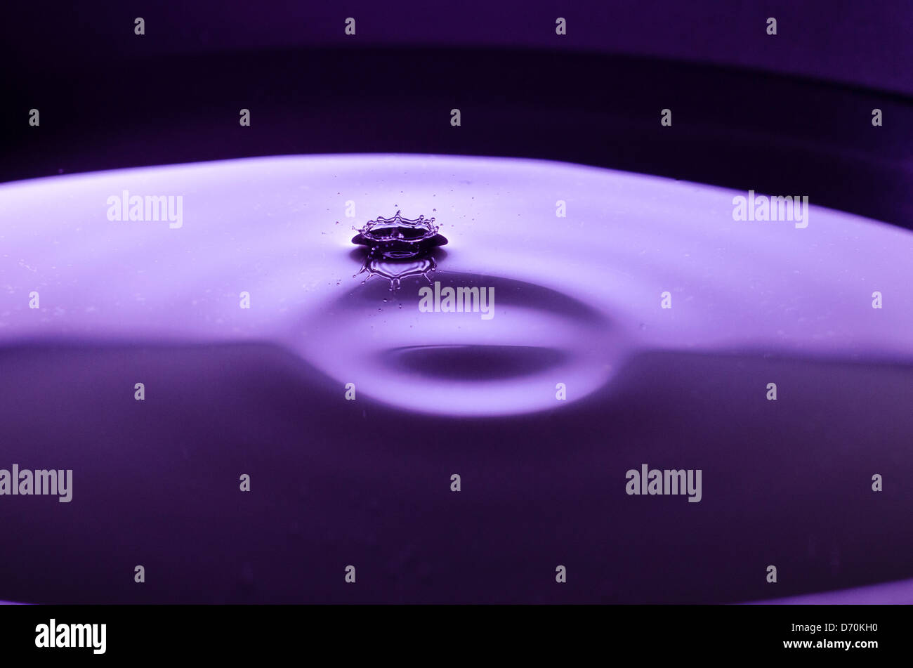 Purple Water drop splash Stock Photo - Alamy