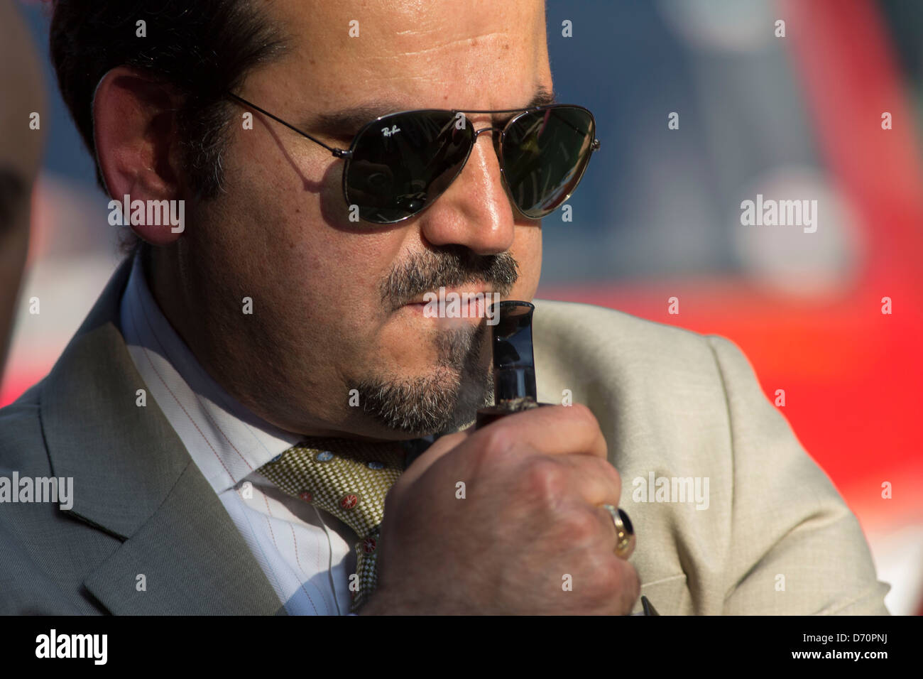 Man smoking a pipe. Foreign journalist reporting on Horse Racing Stock ...