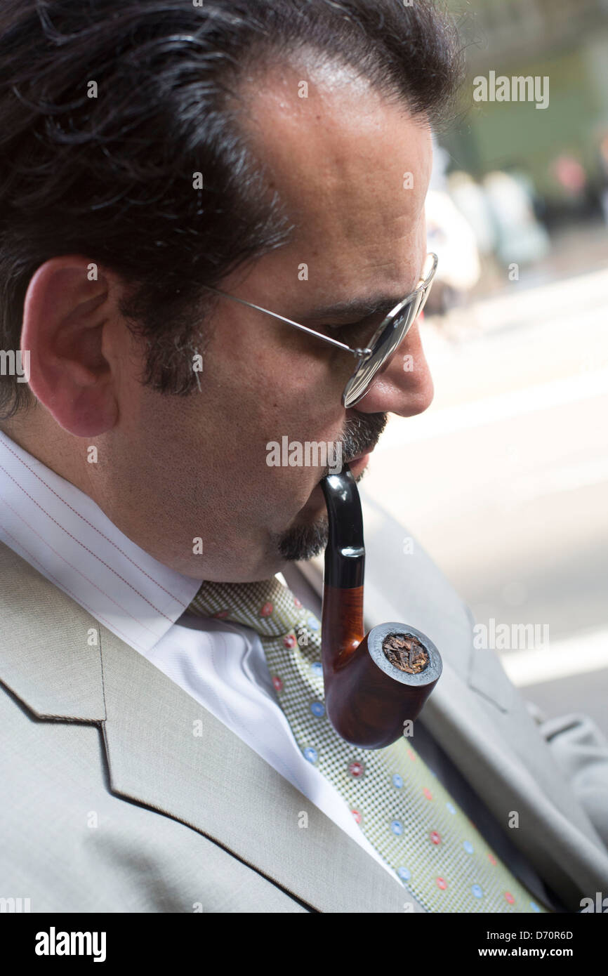Man smoking a pipe. Foreign journalist reporting on Horse Racing Stock ...
