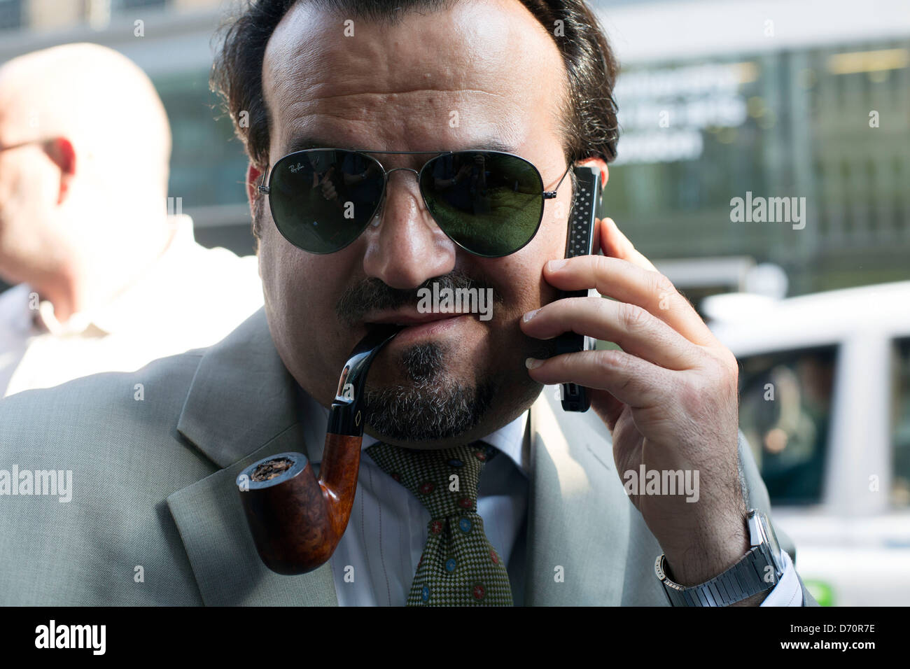 Man smoking a pipe. Foreign journalist reporting on Horse Racing Stock ...