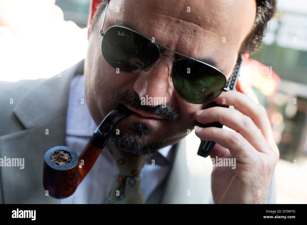Man smoking a pipe. Foreign journalist reporting on Horse Racing Stock ...