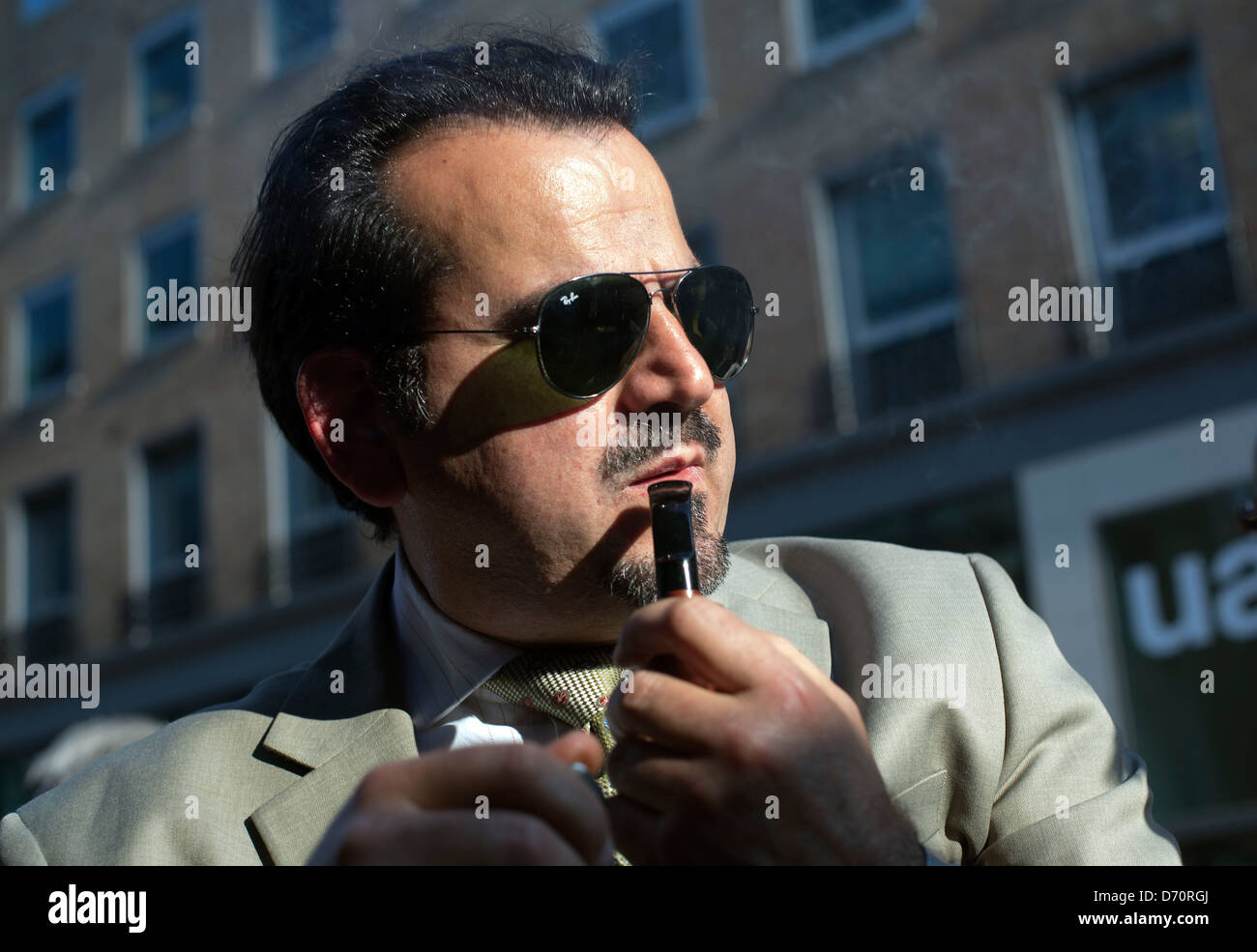 Man smoking a pipe. Foreign journalist reporting on Horse Racing Stock ...