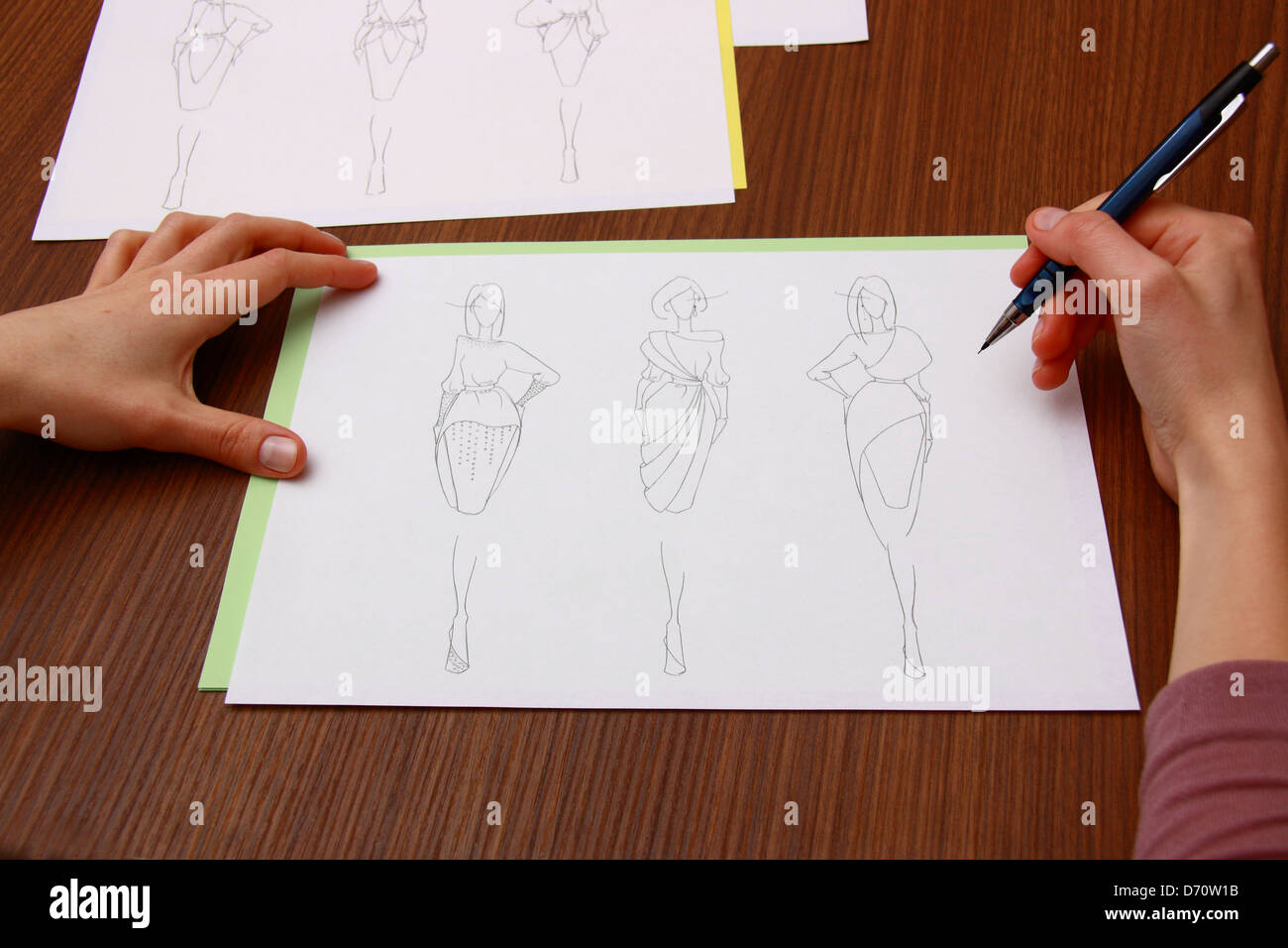 designer assessing fashion drawings on the collection of clothes Stock ...