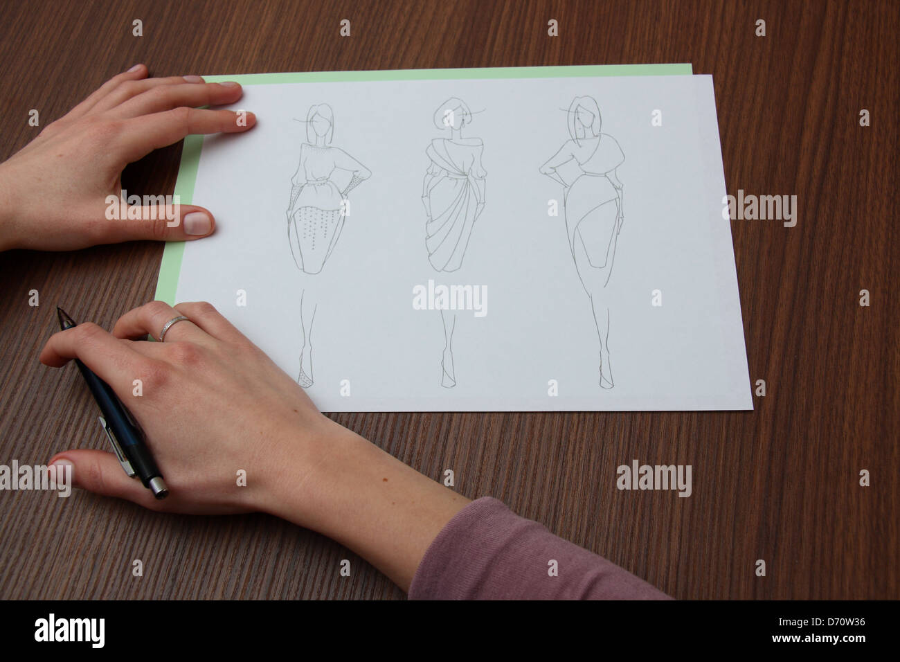 designer assessing fashion drawings on the collection of clothes Stock ...