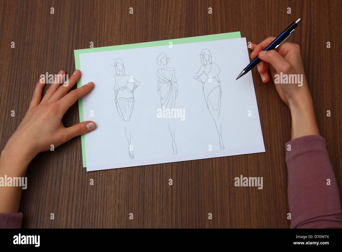 designer assessing fashion drawings on the collection of clothes Stock ...