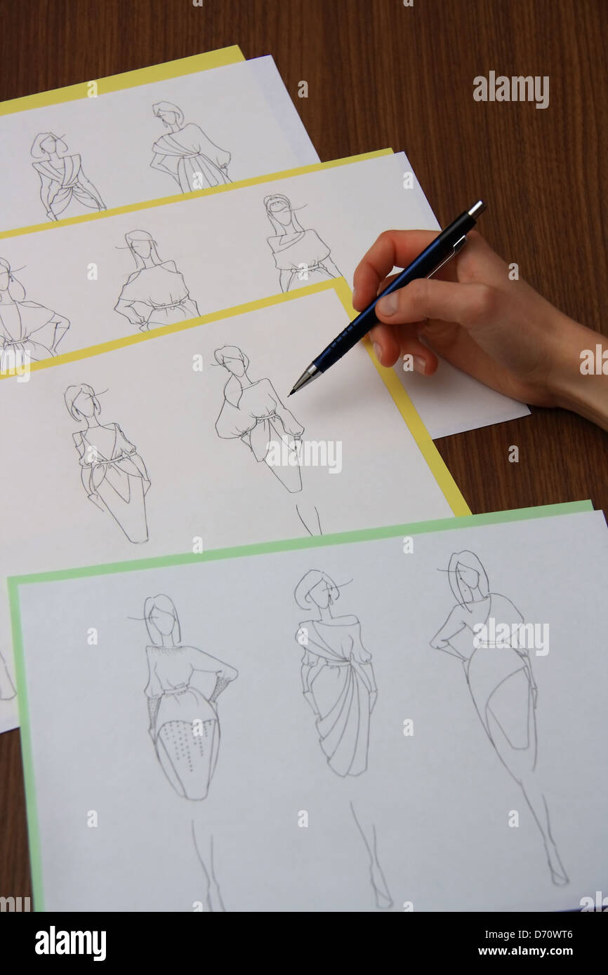 designer assessing fashion drawings on the collection of clothes Stock ...