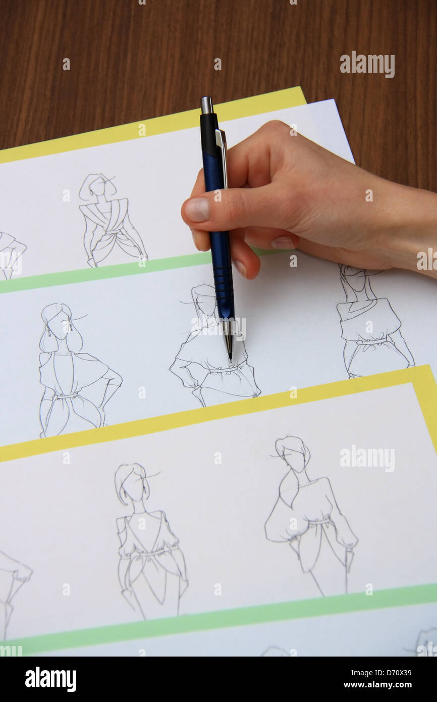 designer assessing fashion drawings on the collection of clothes Stock ...
