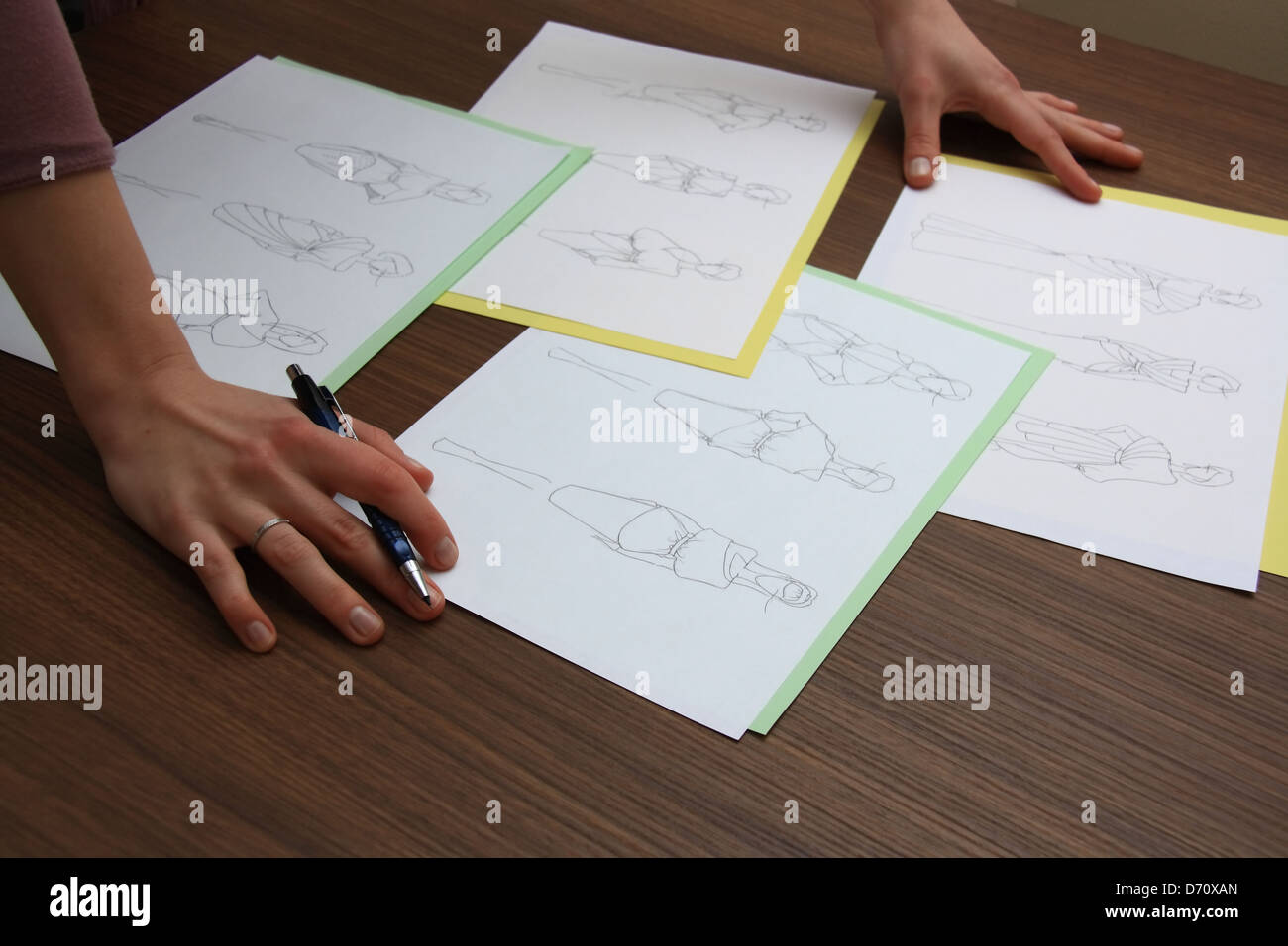 designer assessing fashion drawings on the collection of clothes Stock ...