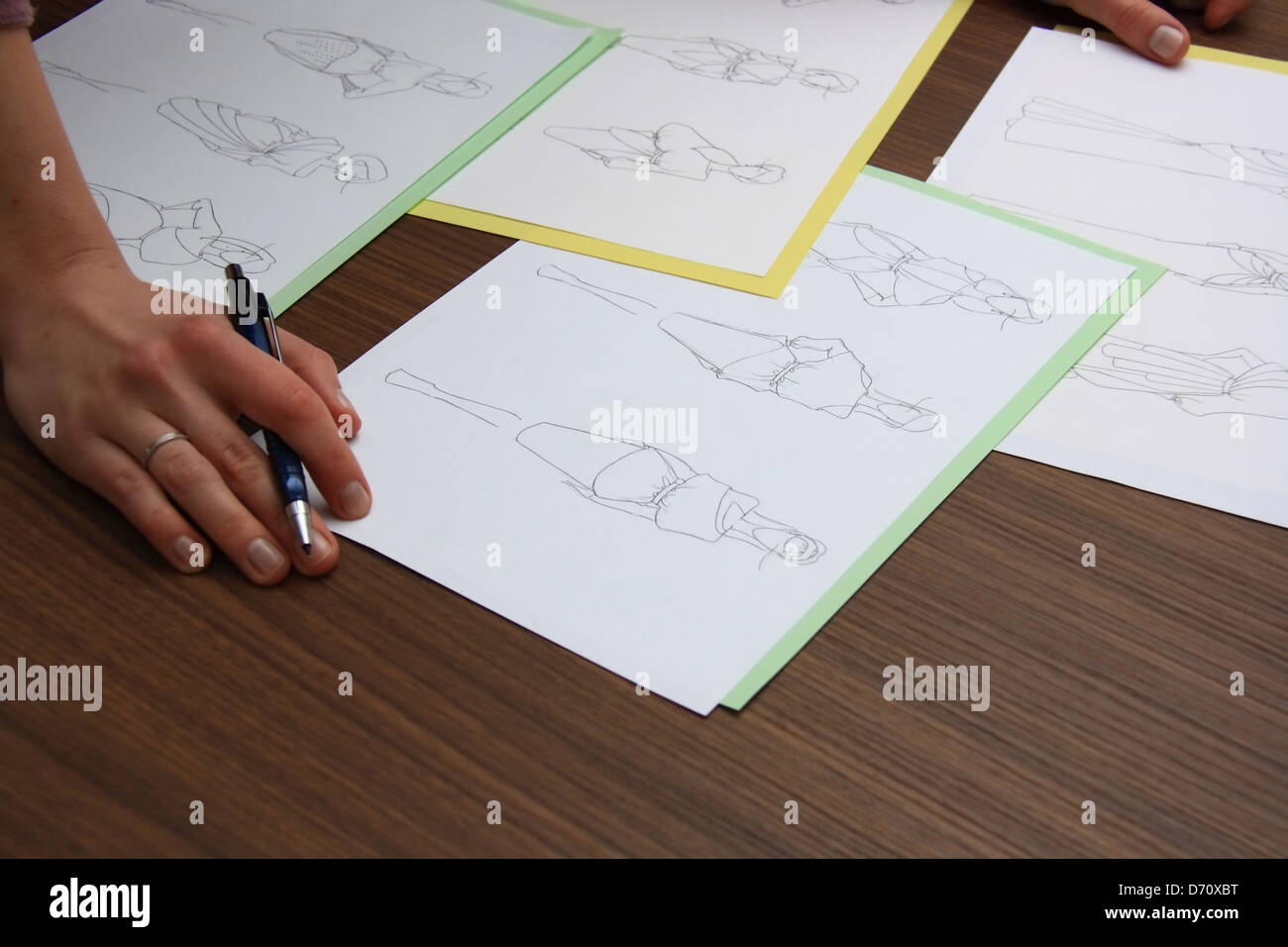 designer assessing fashion drawings on the collection of clothes Stock ...