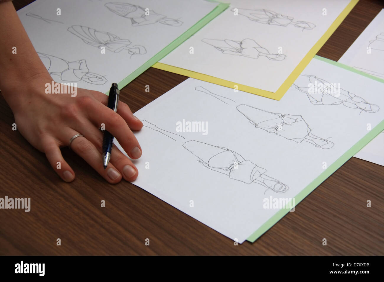 designer assessing fashion drawings on the collection of clothes Stock ...