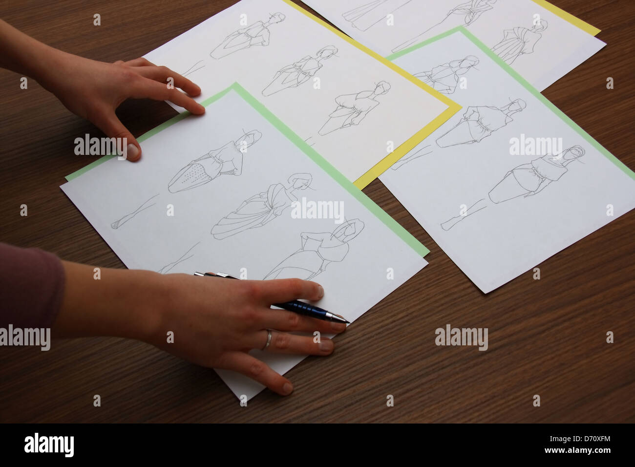 designer assessing fashion drawings on the collection of clothes Stock ...