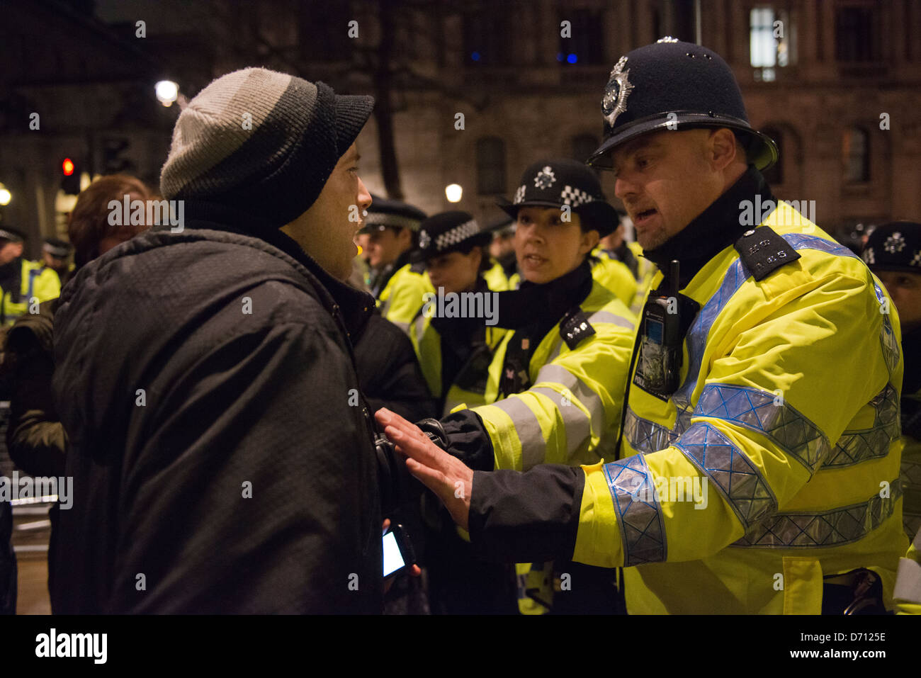 Metropolitan police try to calm down a protester who feels he is being ...