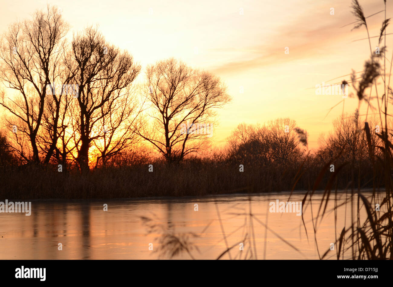 sunset over an icy lake Stock Photo - Alamy