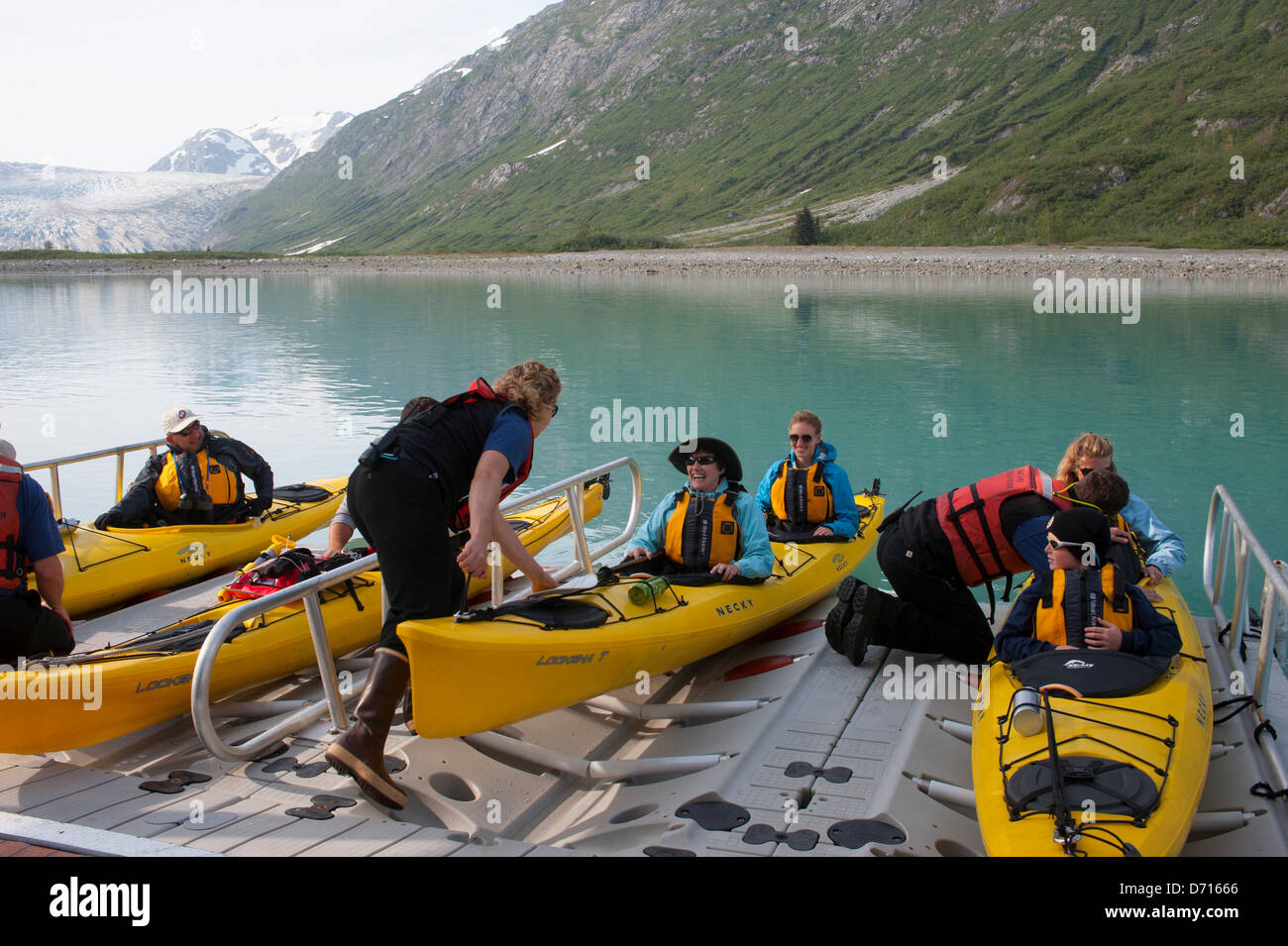 People getting into sea kayaks on loading dock cruise ship Safari ...