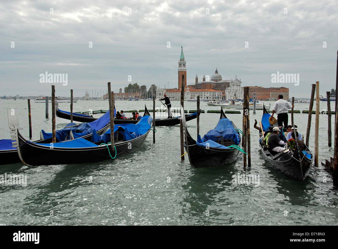 Gondolas and gondolier in Venice, Italy Stock Photo - Alamy