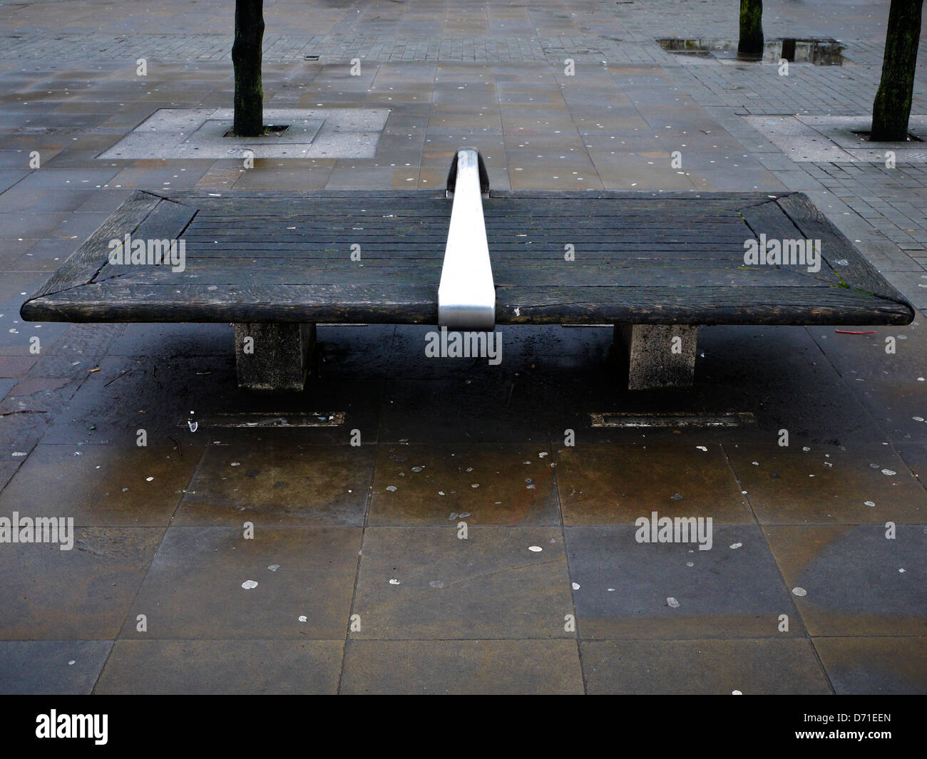 Wooden bench in the rain, Manchester UK Stock Photo - Alamy