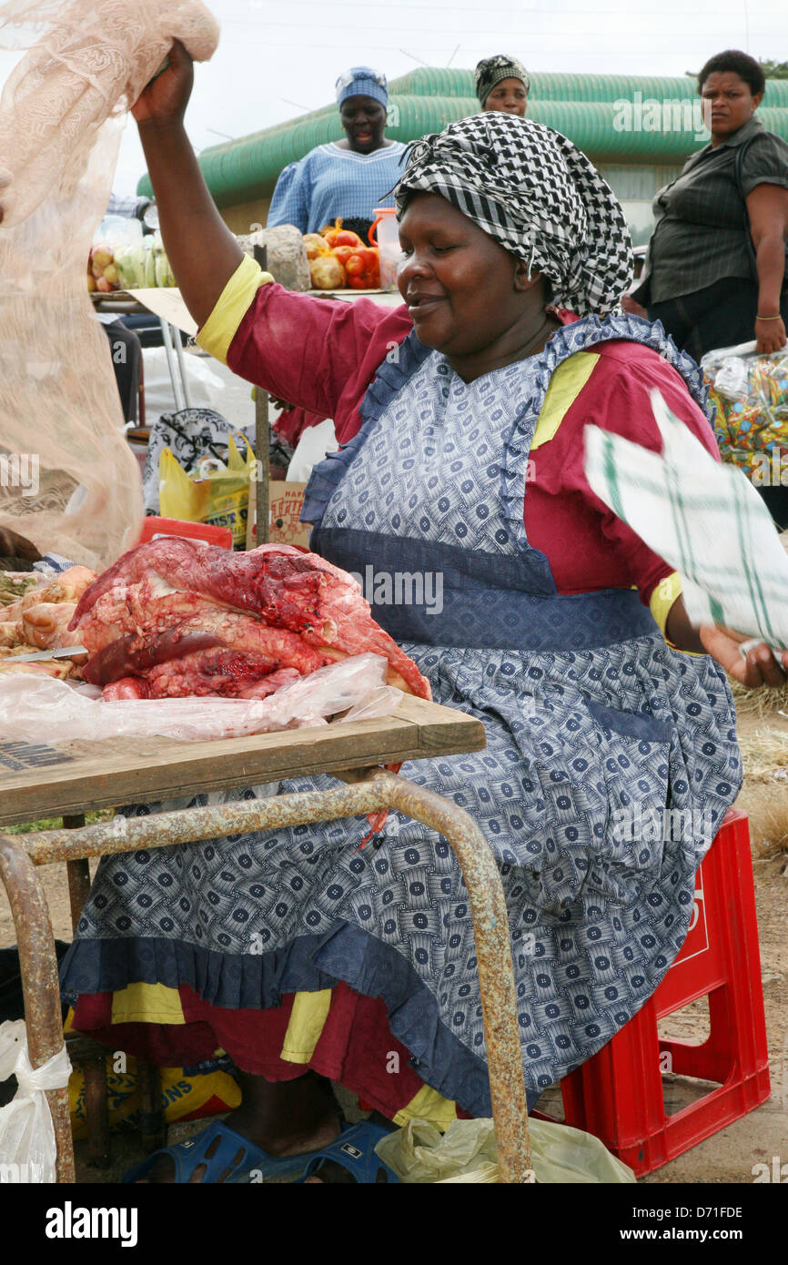 African woman selling sheep meat at a stall Stock Photo - Alamy