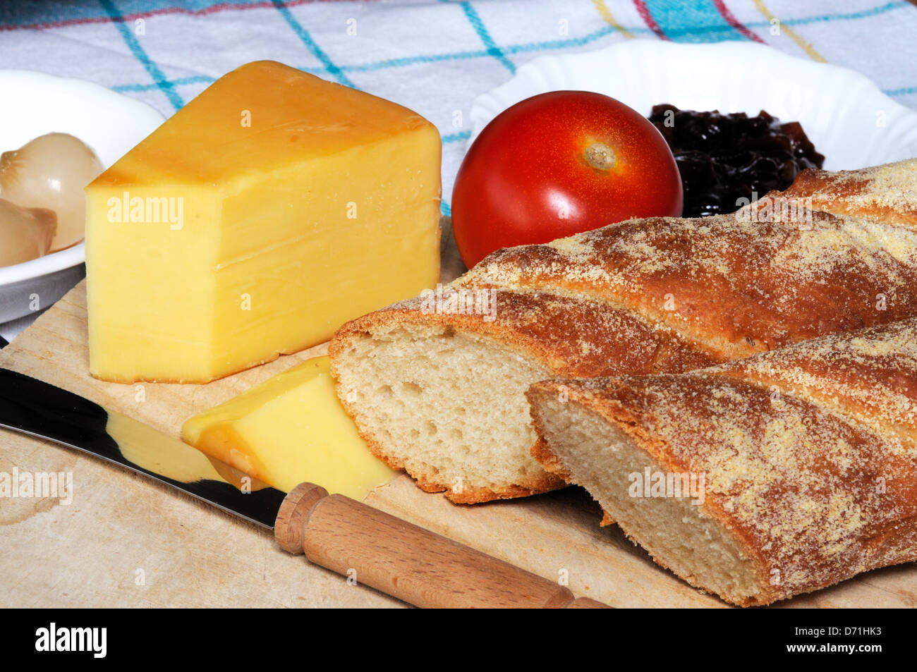 Ploughmans lunch comprising of white bread, cheddar cheese and pickle ...