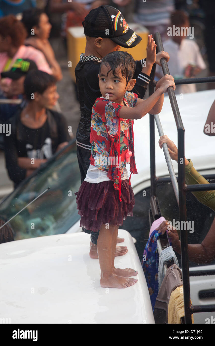 Two small children hold on tight atop a moving vehicle as they get to ...