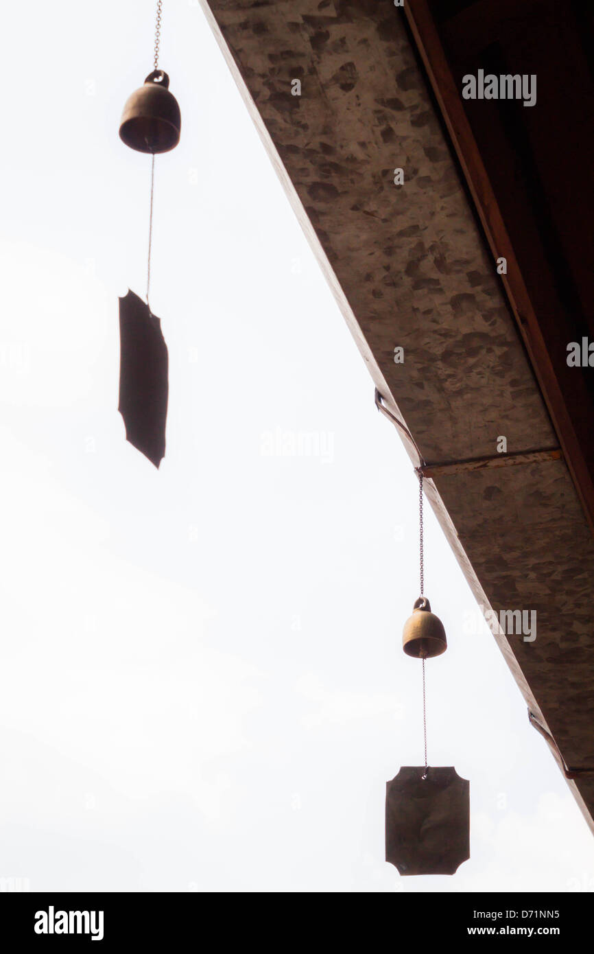 Small wind bell hang on eaves with white background Stock Photo - Alamy