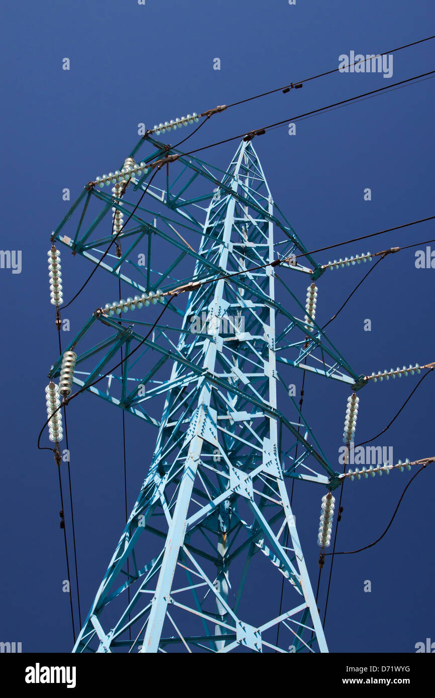 Steel lattice high-voltage transmission tower against deep-blue sky ...