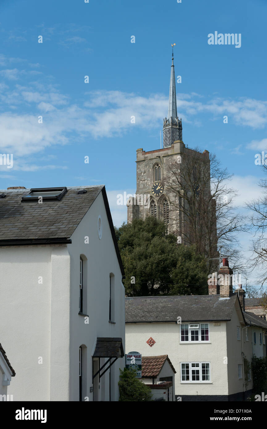 A village scene with the tower of St Mary's church behind cottages in ...