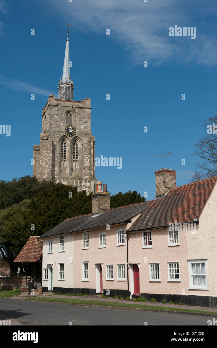 A village scene with the tower of St Mary's church behind cottages in ...