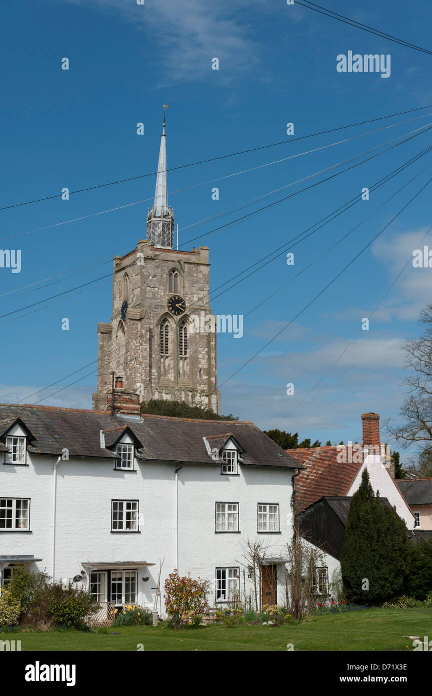 A village scene with the tower of St Mary's church behind cottages in ...