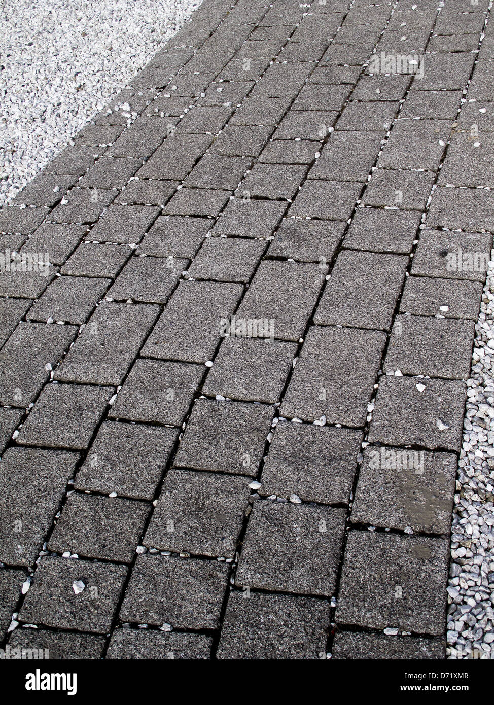 Concrete paving stone path with gravel Stock Photo - Alamy