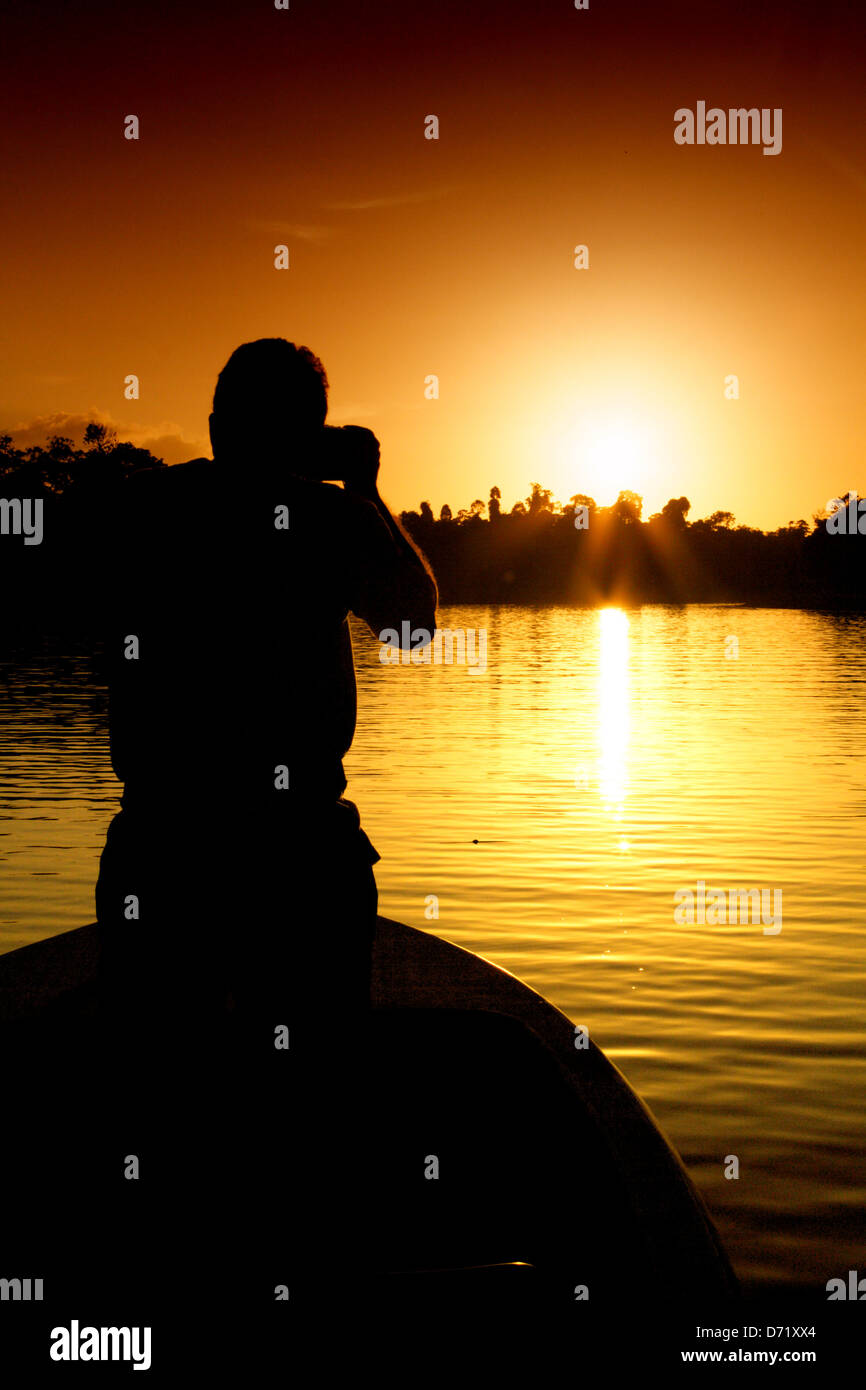 A photographer on the river in the sunset Stock Photo - Alamy